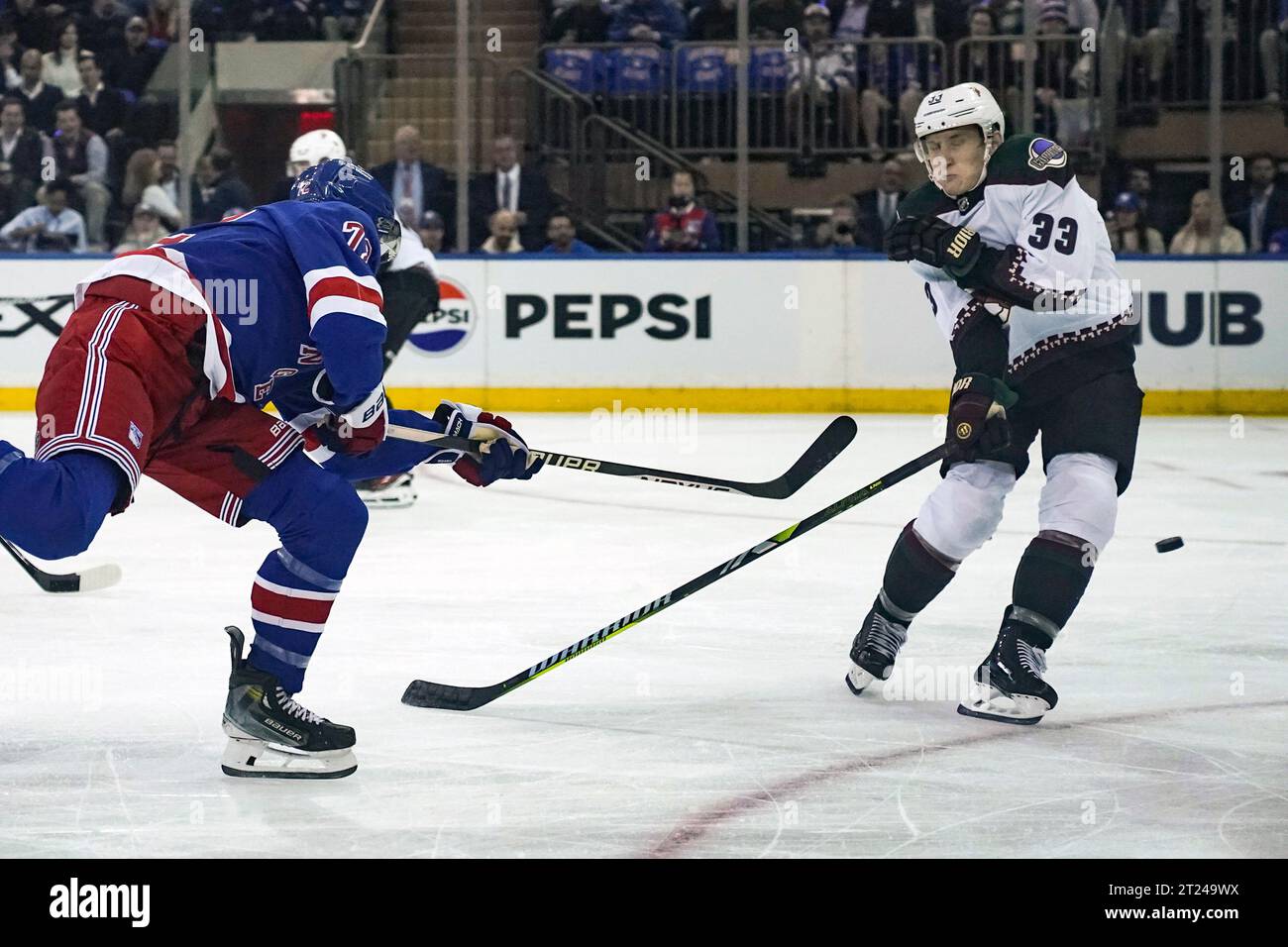 Arizona Coyotes' Travis Dermott, right, reacts as New York Rangers ...