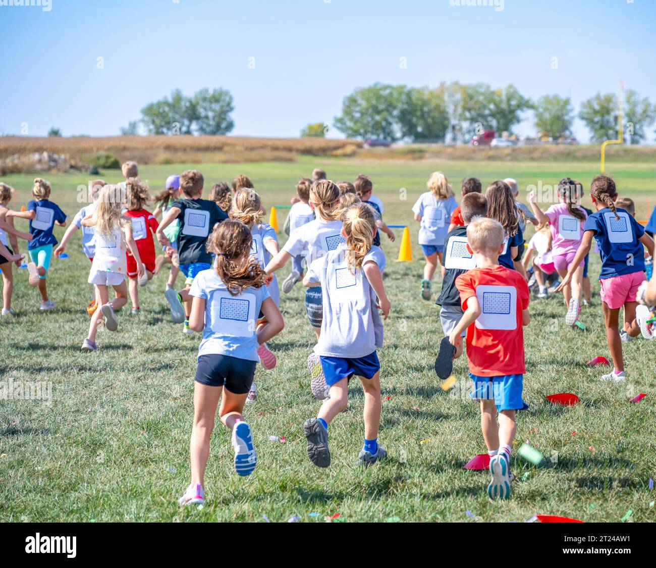 Group of elementary school age children running forward during a ...