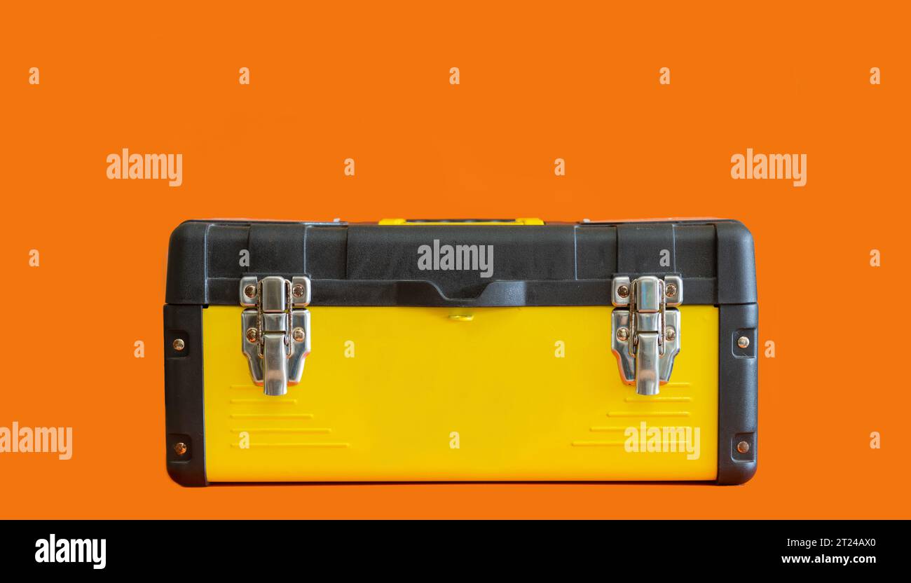 yellow toolbox on orange background Stock Photo - Alamy