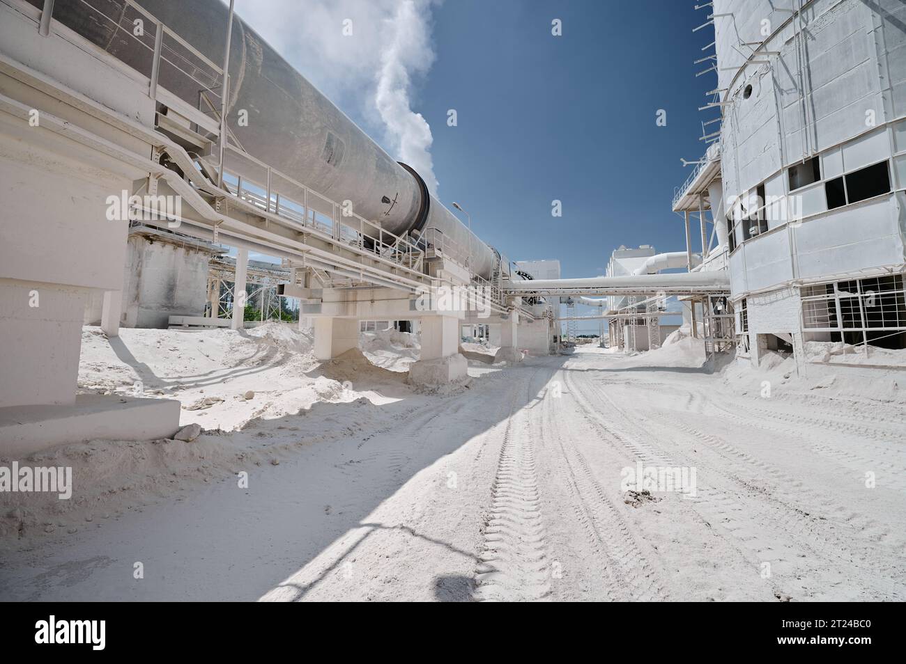 Long rotary furnace for limestone against smoking chimney Stock Photo ...