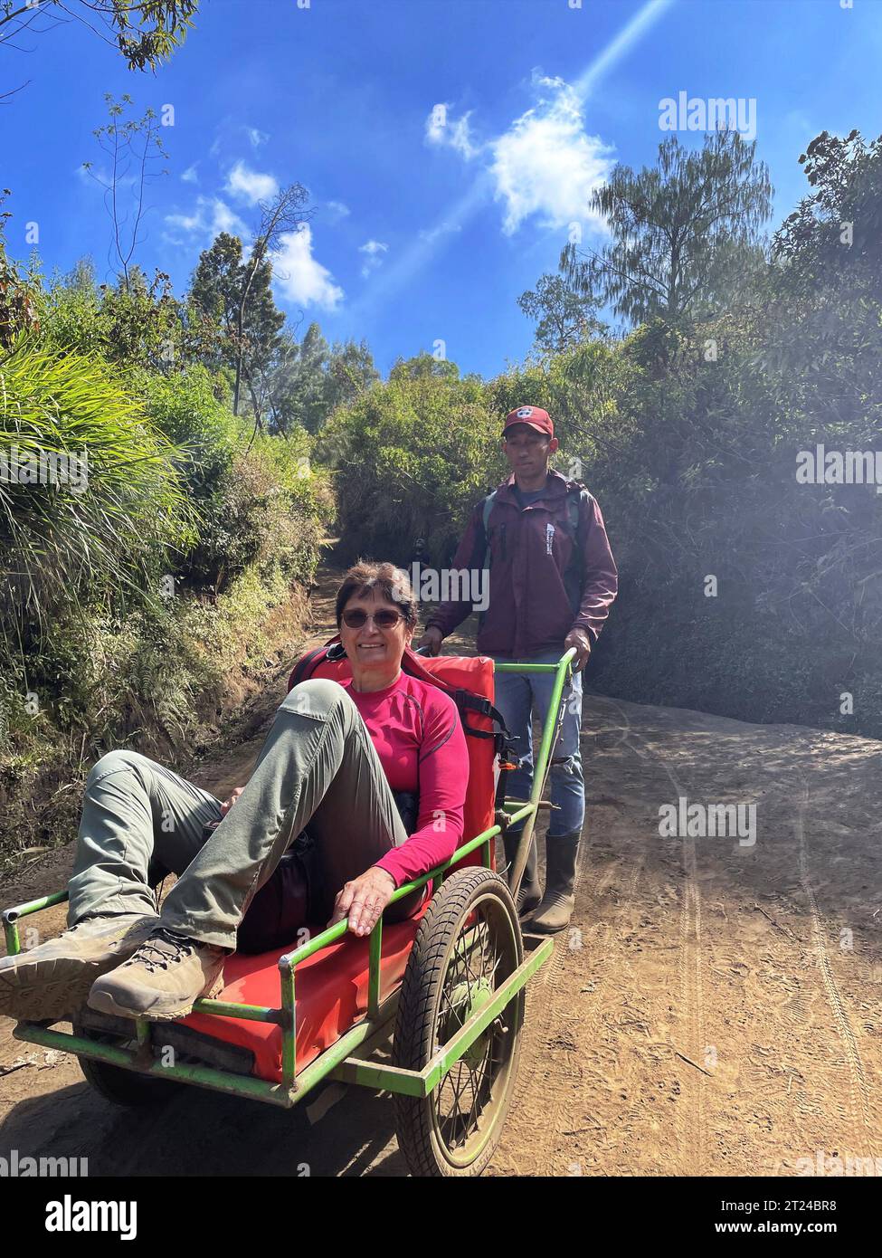 Female tourist is wheeled down the Ijen volcano on a cart Stock Photo ...