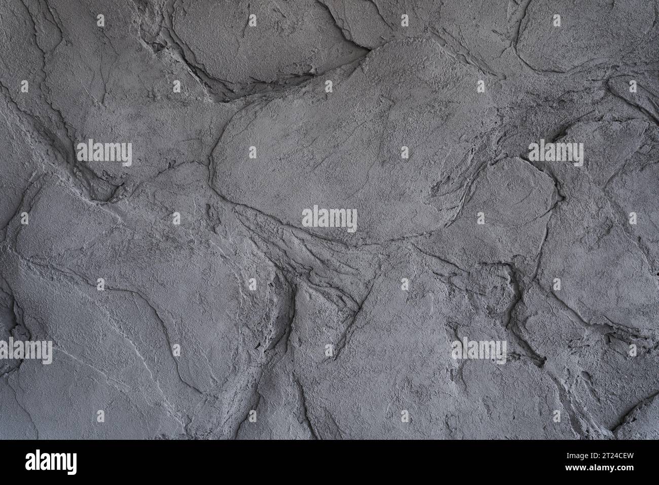 The gray texture of the stone. The cracked layered surface of the ...
