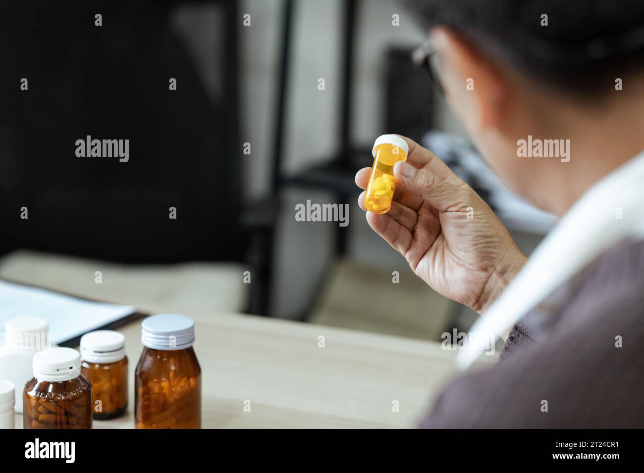 Old man is taking medication according to schedule set by doctor Stock ...