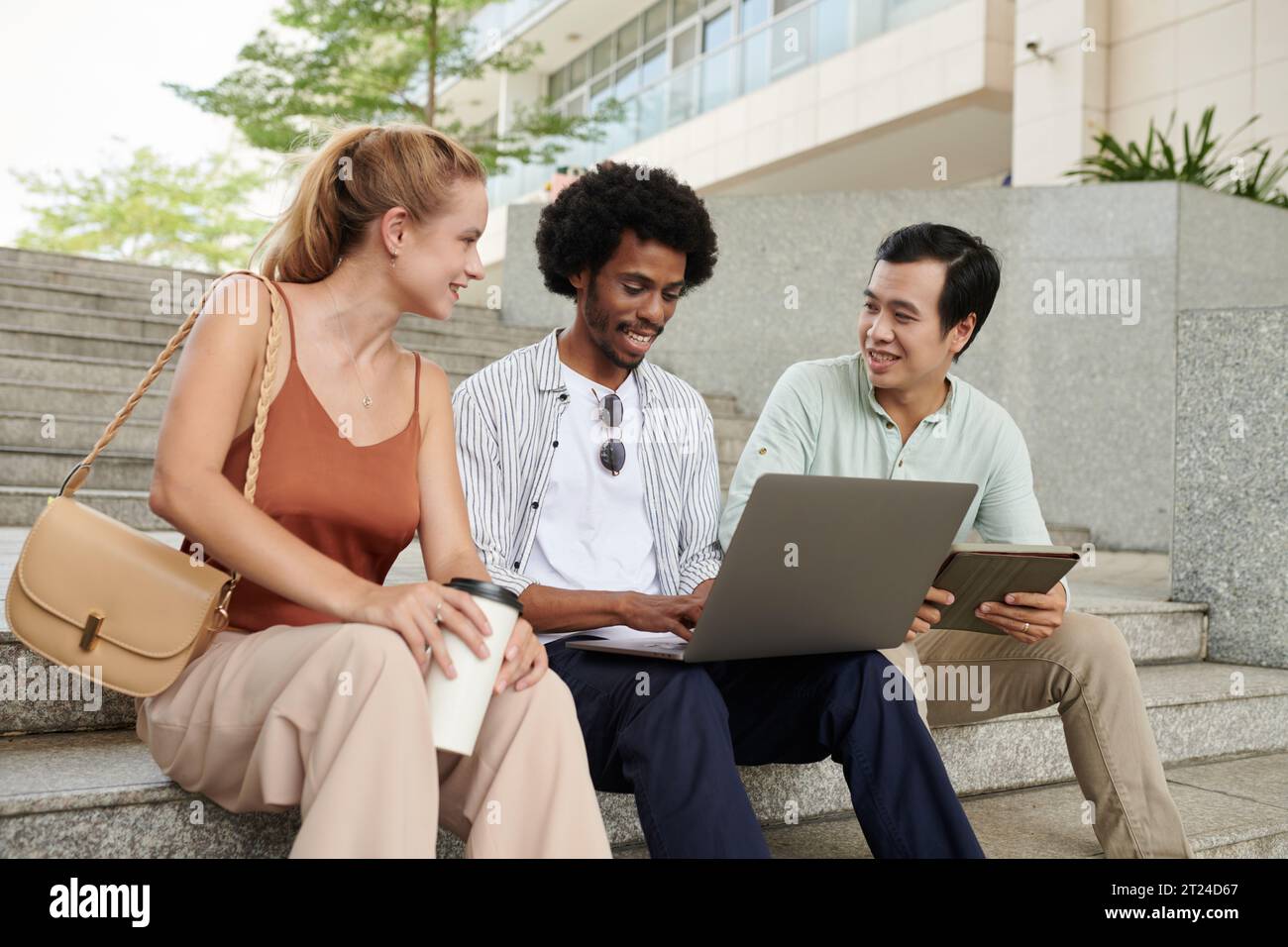 Diverse group of startuppers discussing features of new project they ...