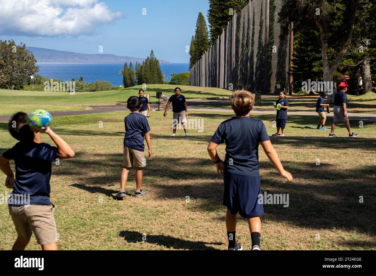 Sacred Hearts School third grade students throw a ball during recess at ...