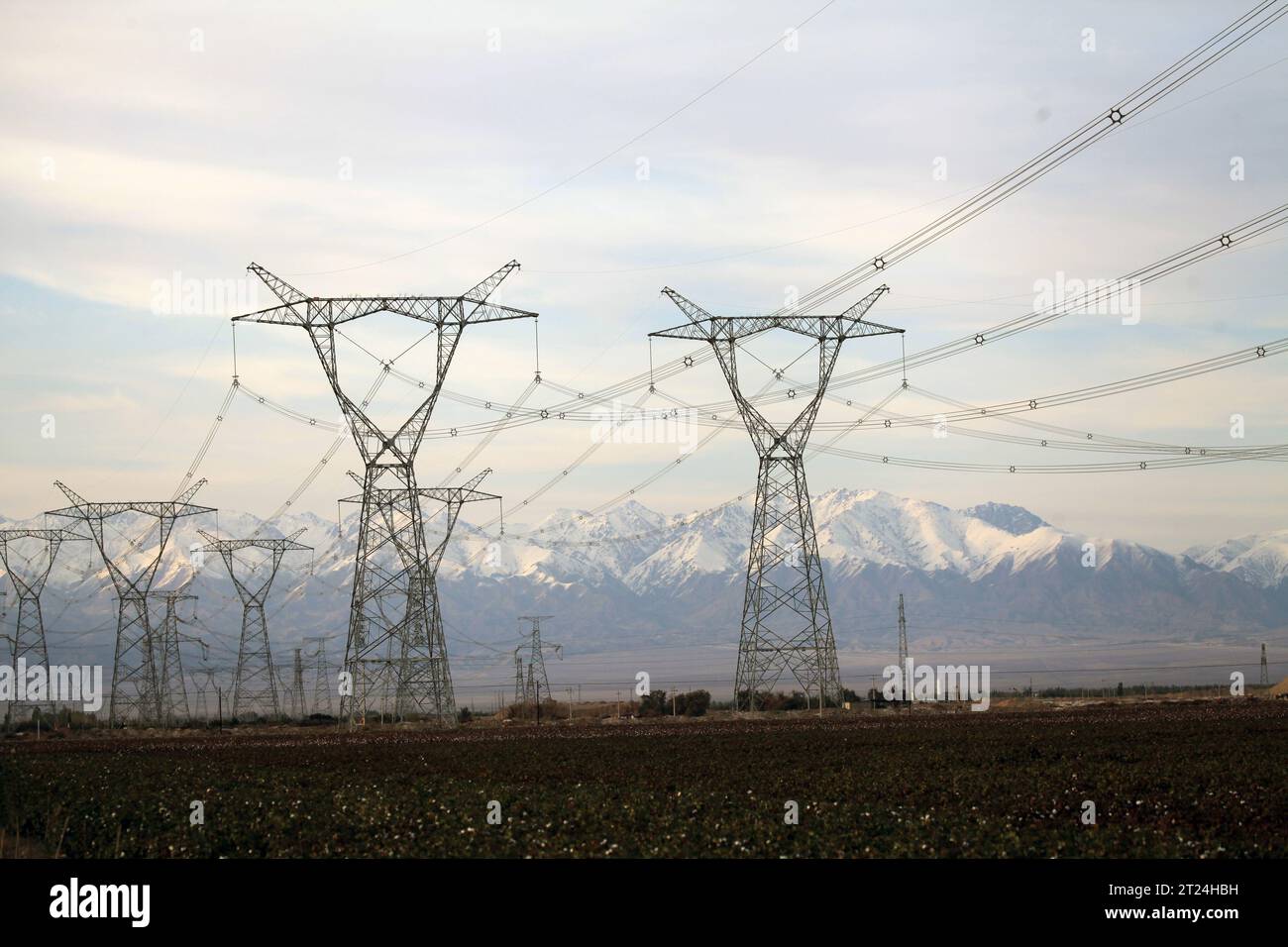 The State Grid under a snowy mountain in Hami, Xinjiang, China, September 30, 2023 Stock Photo ...