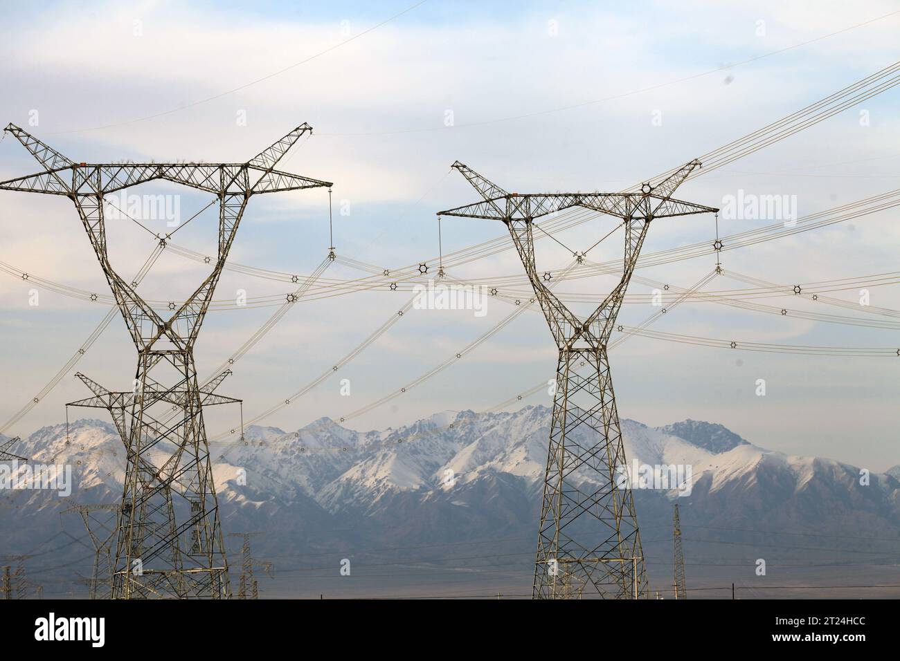 The State Grid under a snowy mountain in Hami, Xinjiang, China ...