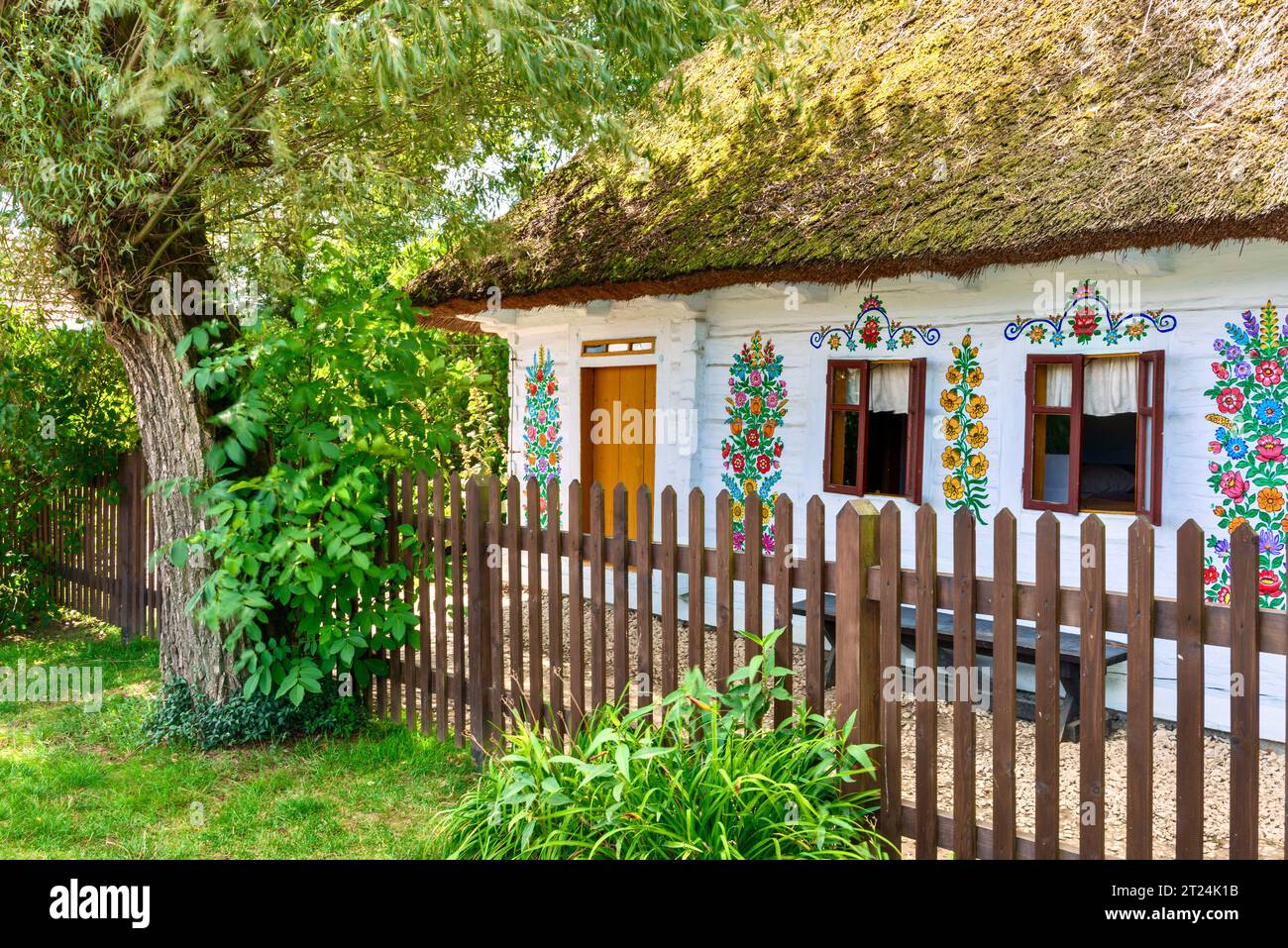 A fragment of a traditional Polish house with a thatched roof and a ...