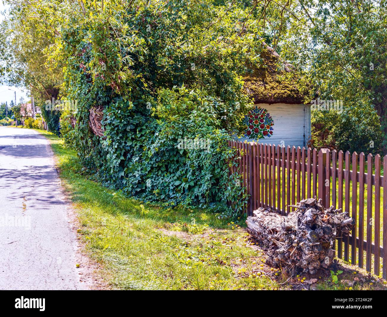 A fragment of a traditional Polish house with a thatched roof and a ...