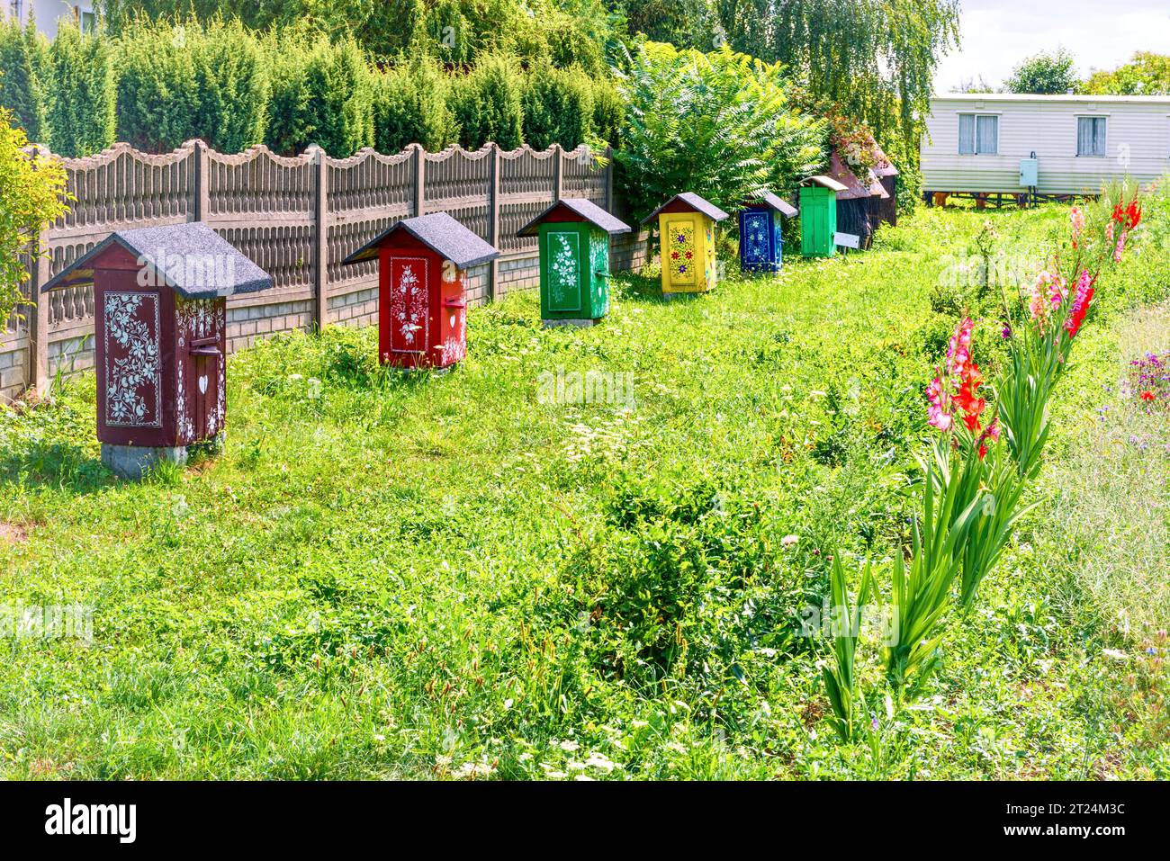 View of an apiary with colorful beehives with floral patterns Stock ...