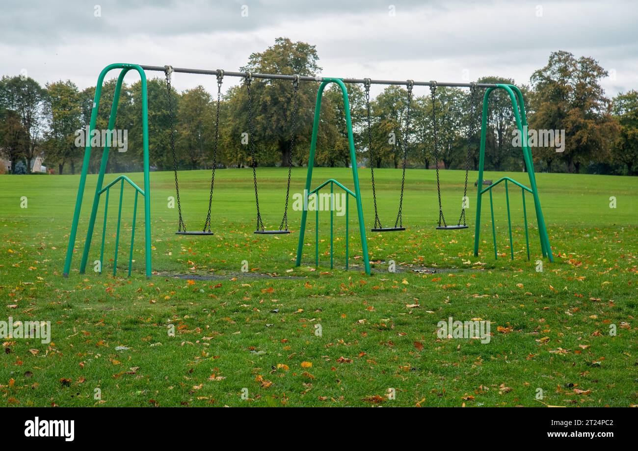 Swings in a children's play park Stock Photo - Alamy