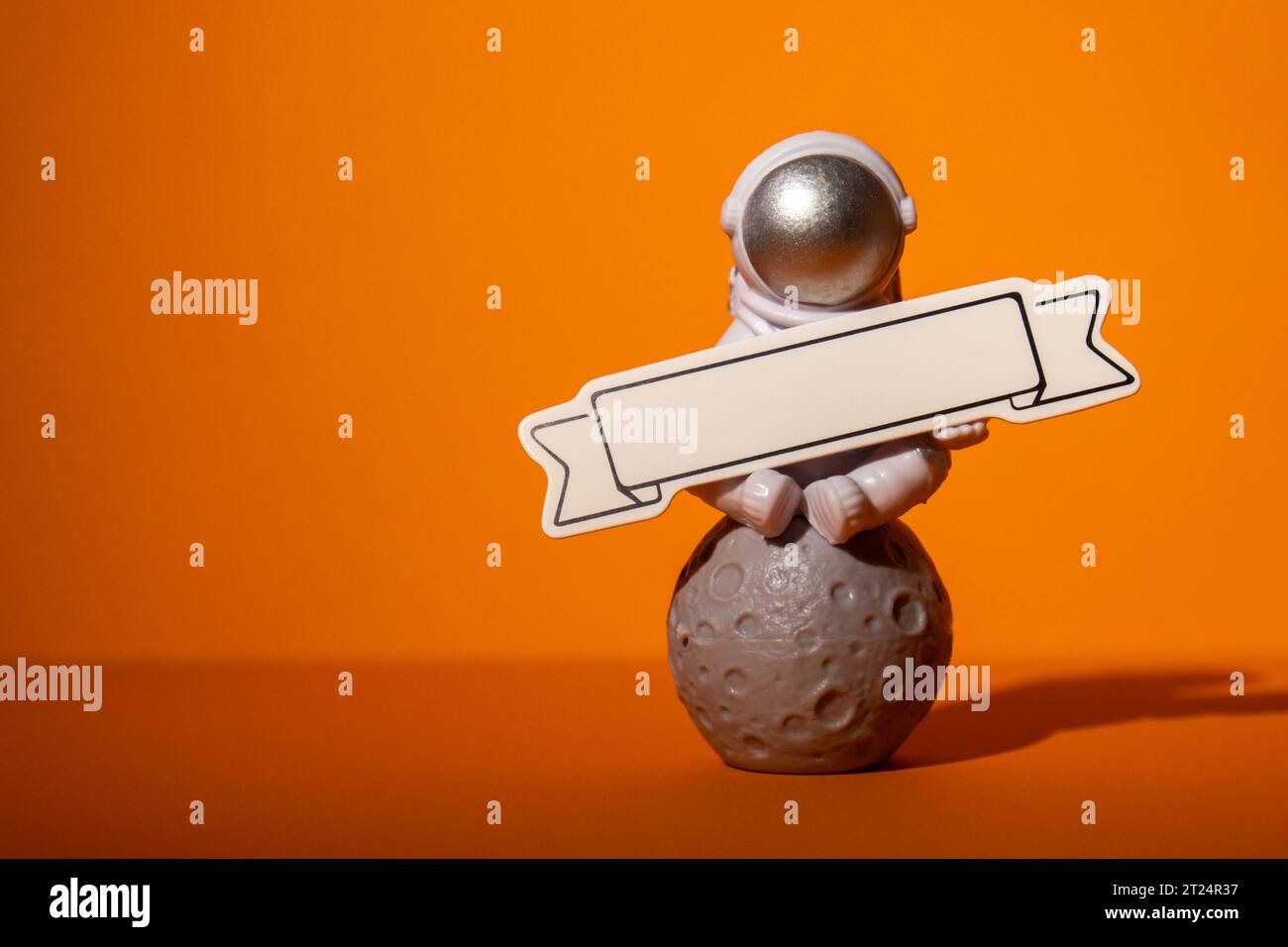 Plastic toy astronaut with paper note template mock up for your text on ...