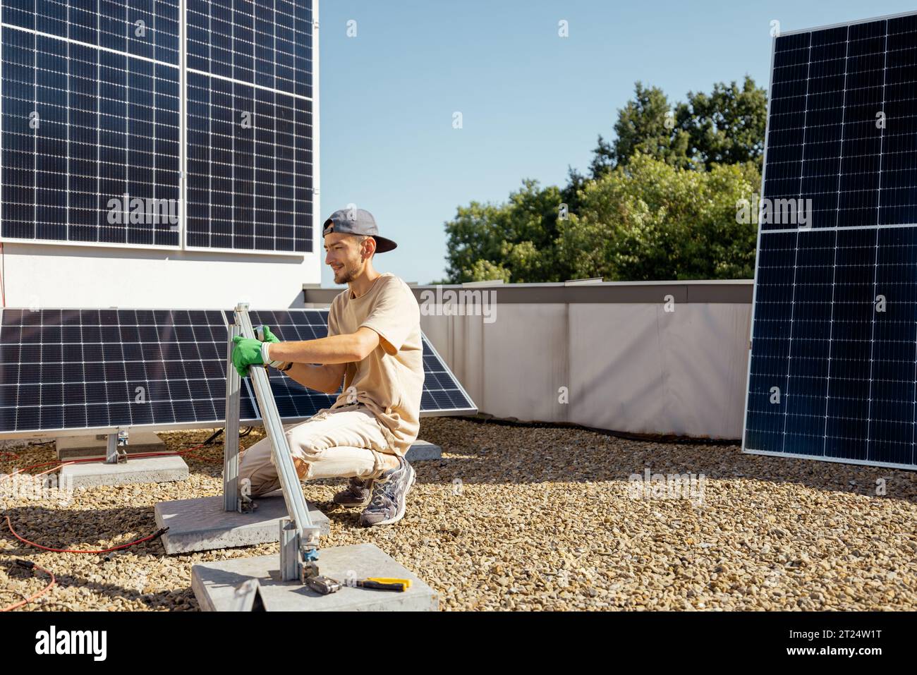Man installing solar power plant on a house rooftop Stock Photo - Alamy