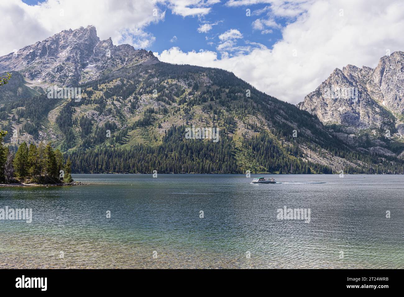 Jenny Lake and the Teton Range with a shuttle on the lake in the Grand ...