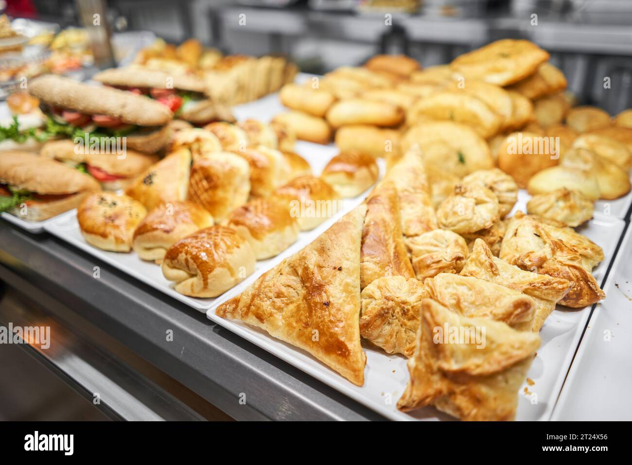 Fresh sandwiches, pies and pizza to choose from in the window of a cafe, buffet or self-service ...