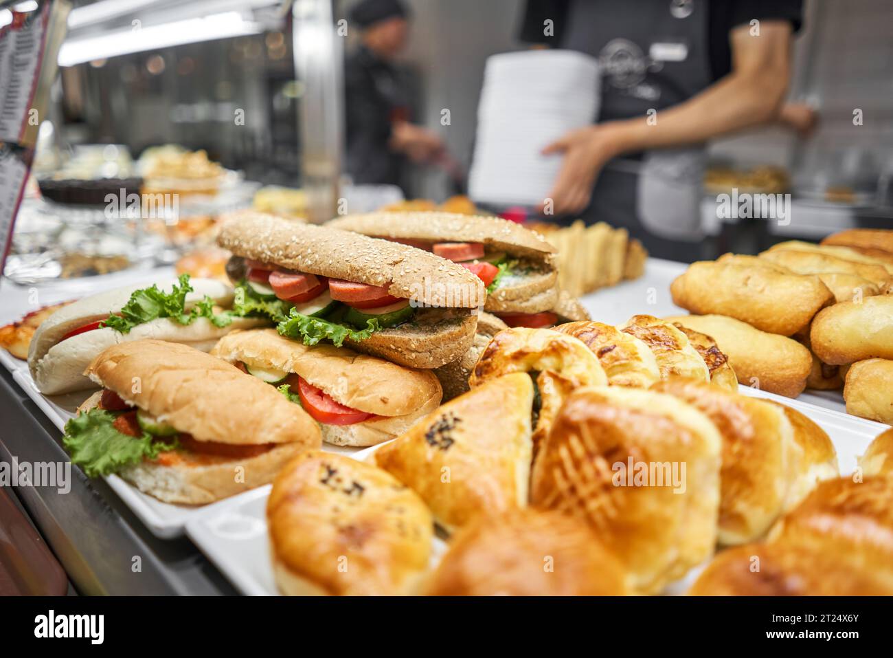 Fresh sandwiches, pies and pizza to choose from in the window of a cafe, buffet or self-service ...