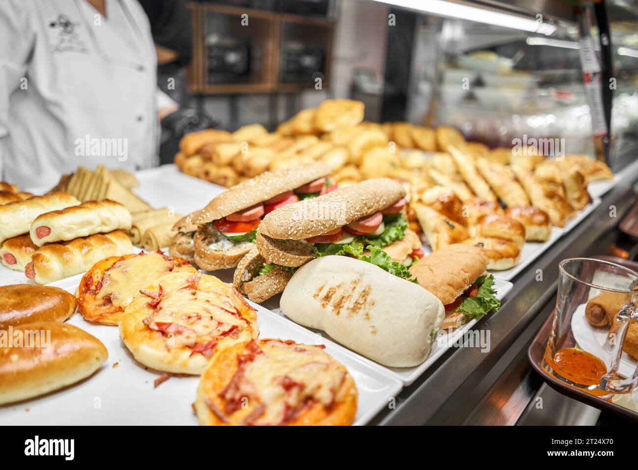 Fresh sandwiches, pies and pizza to choose from in the window of a cafe, buffet or self-service ...