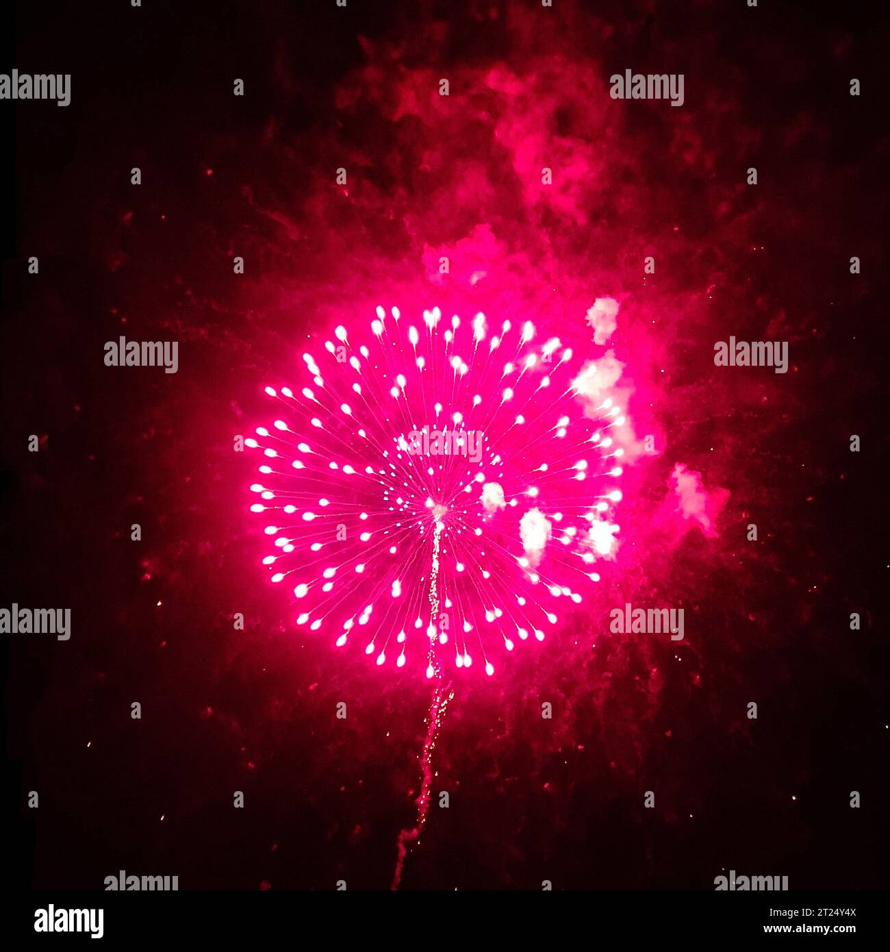 Circle explosion of festive real fireworks with red smoke on black ...