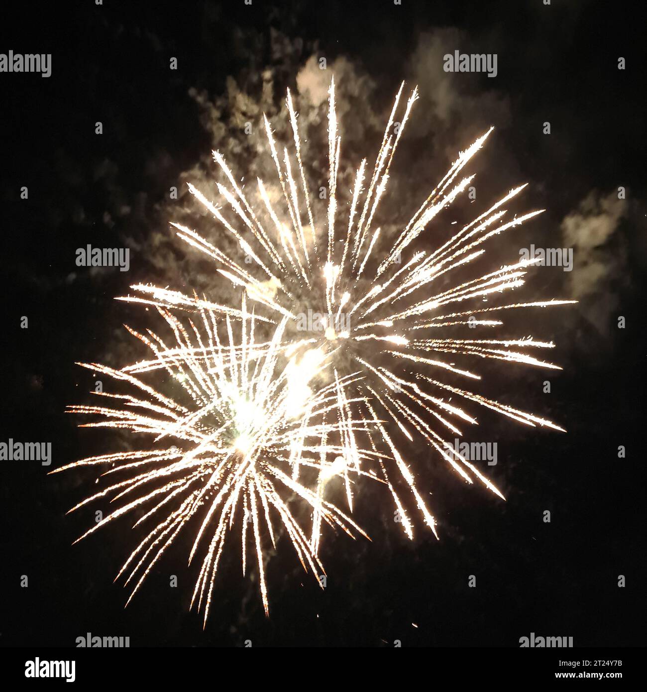 2 fireworks explosions with smoke paths on black sky background for ...
