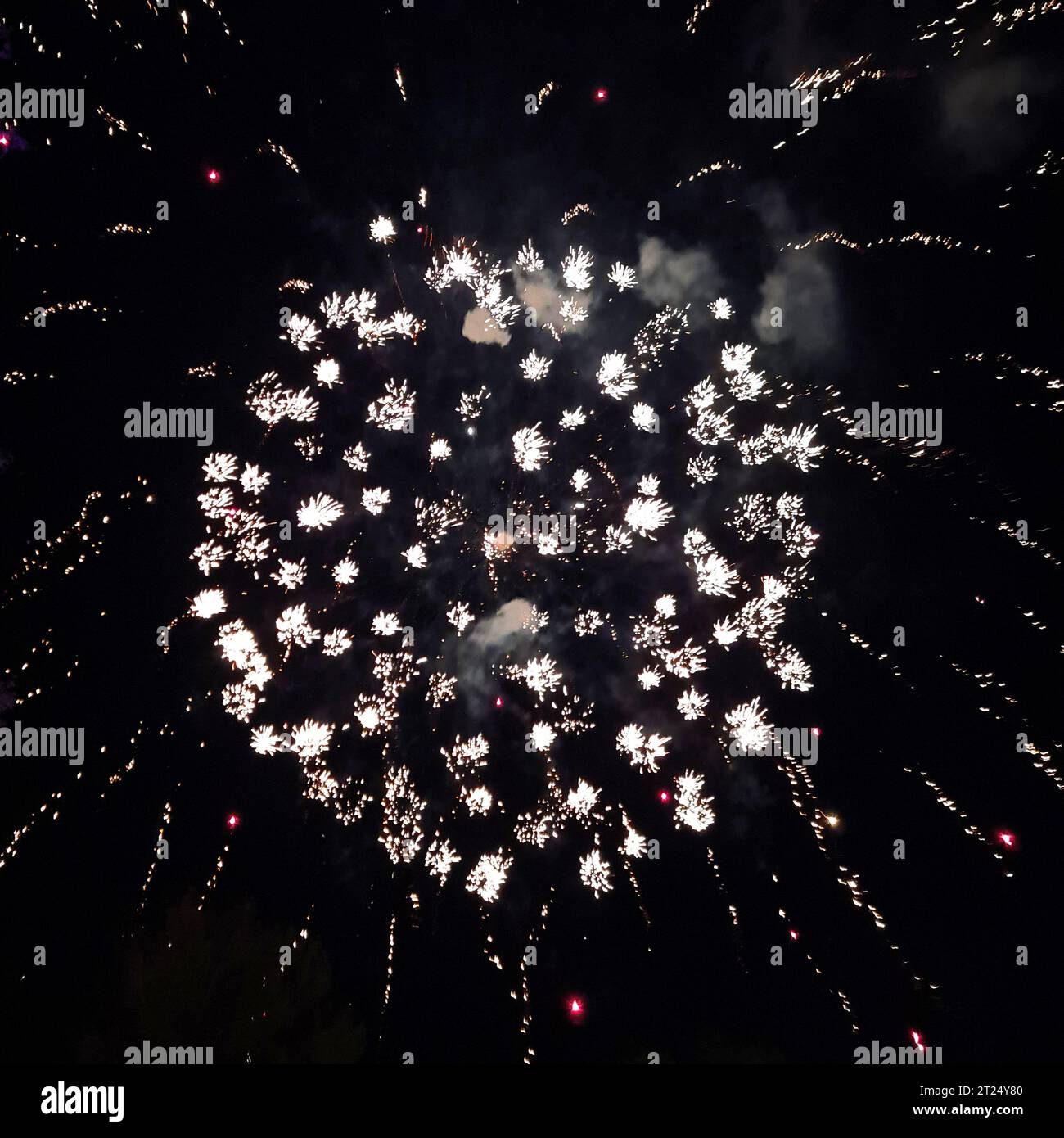 Explosion of festive real fireworks with motion blur sparks on black ...