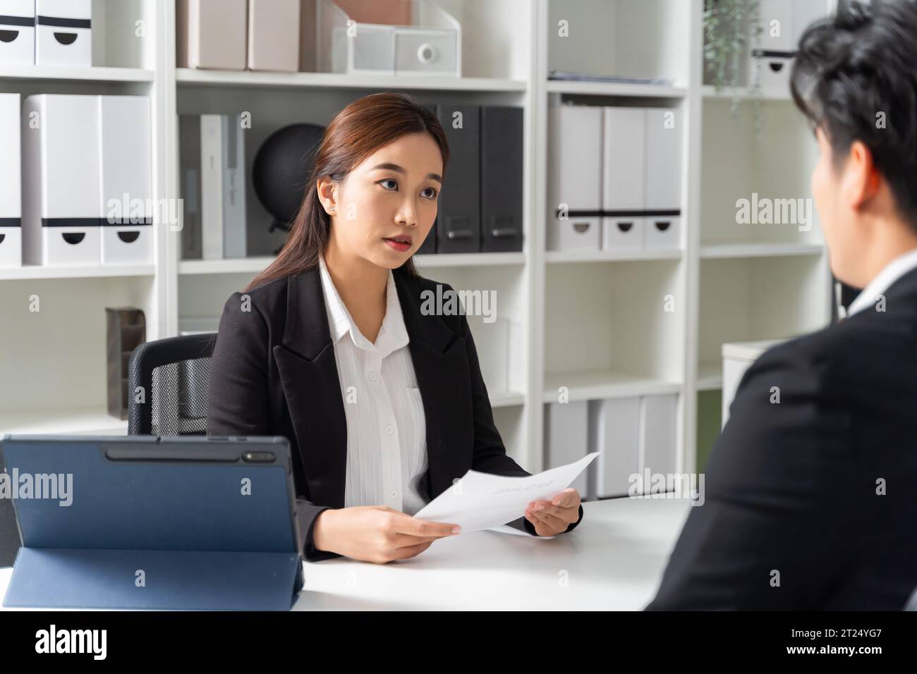 Asian female business entrepreneur recruiting a young adult business ...