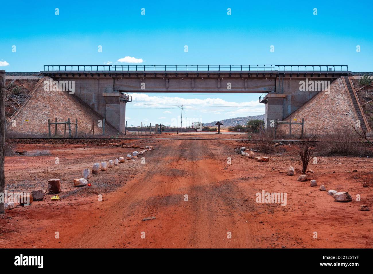 A dirt road below a railway bridge at Tsavo East Nationa Park, Kenya ...