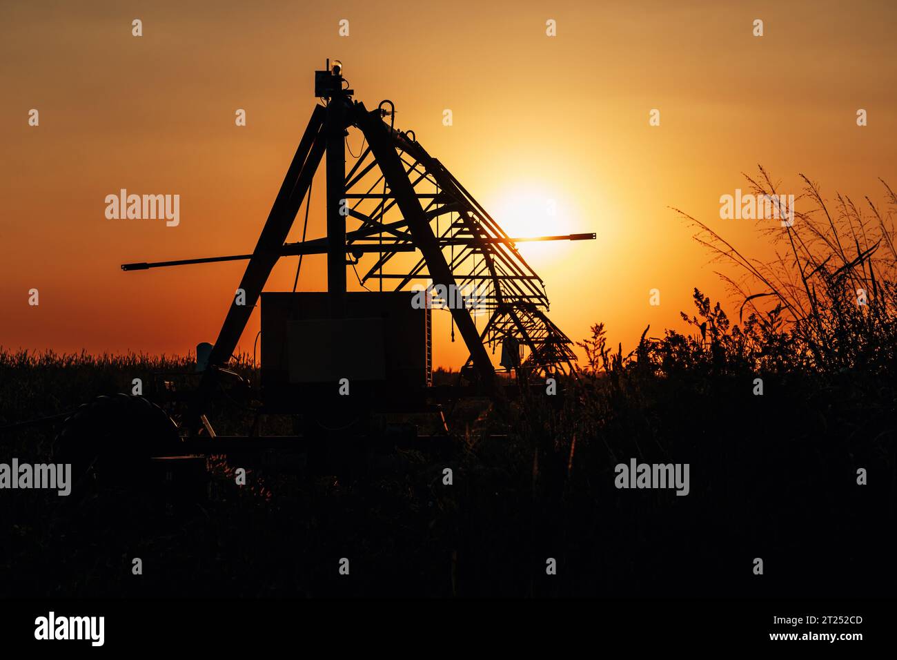 Silhouette of automated farming irrigation pivot sprinkler system in ...