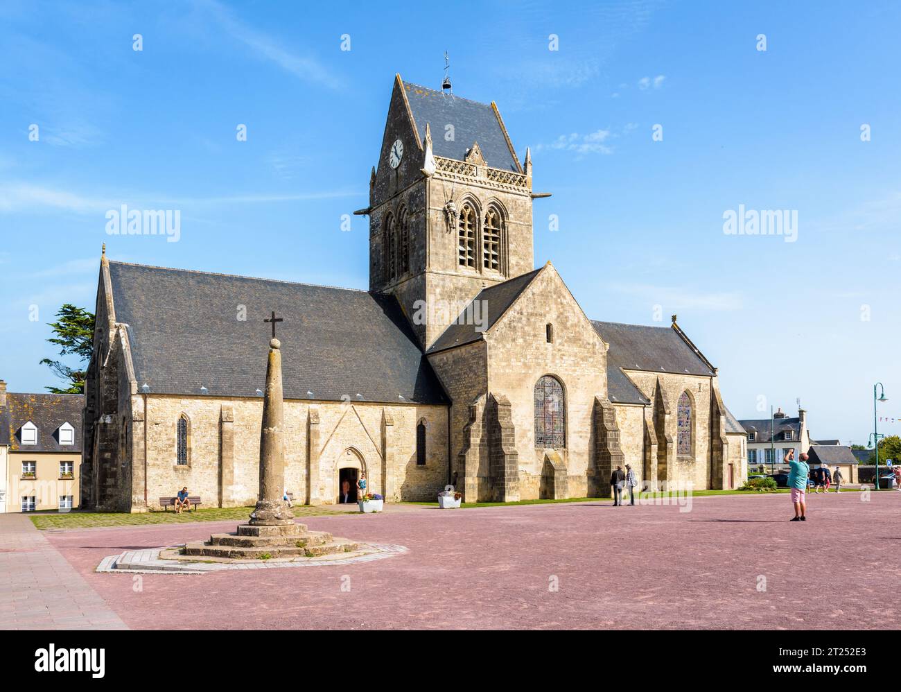 General view of Sainte-Mere-Eglise's church with a paratrooper dummy ...