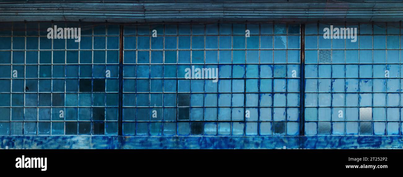 Old factory warehouse grid windows with broken glass as industrial ...