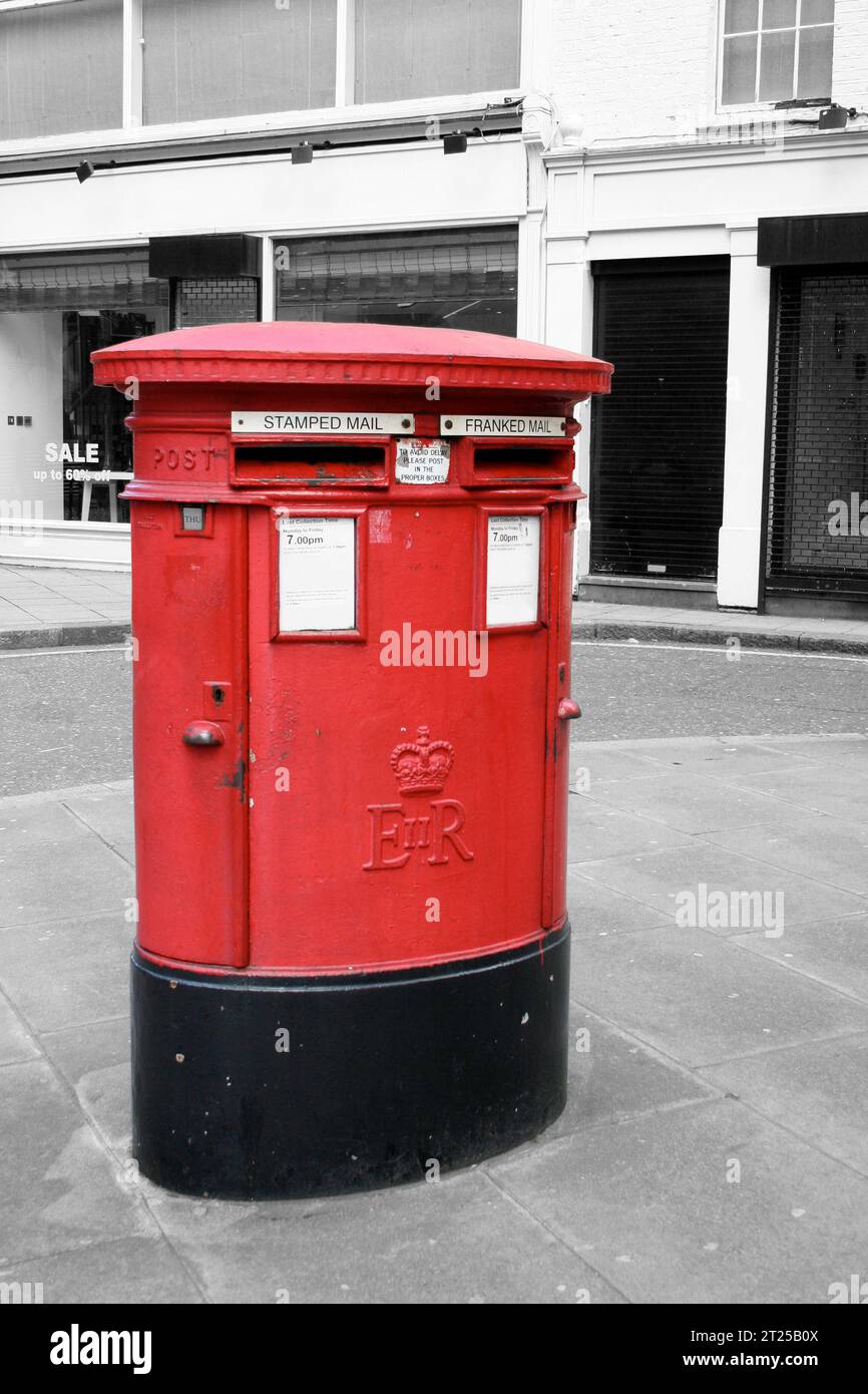 Color isolated English red double aperture pillar box on black and ...