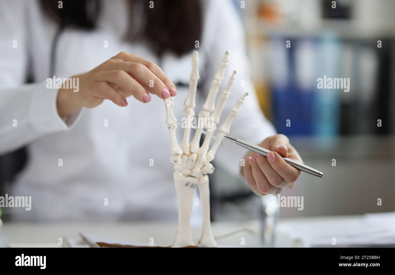 Female scientist explore human skeleton hand model, laboratory and ...