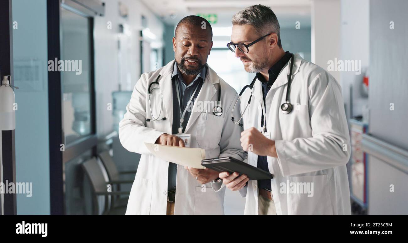 Doctors, teamwork and advice with documents, hospital folder and ...