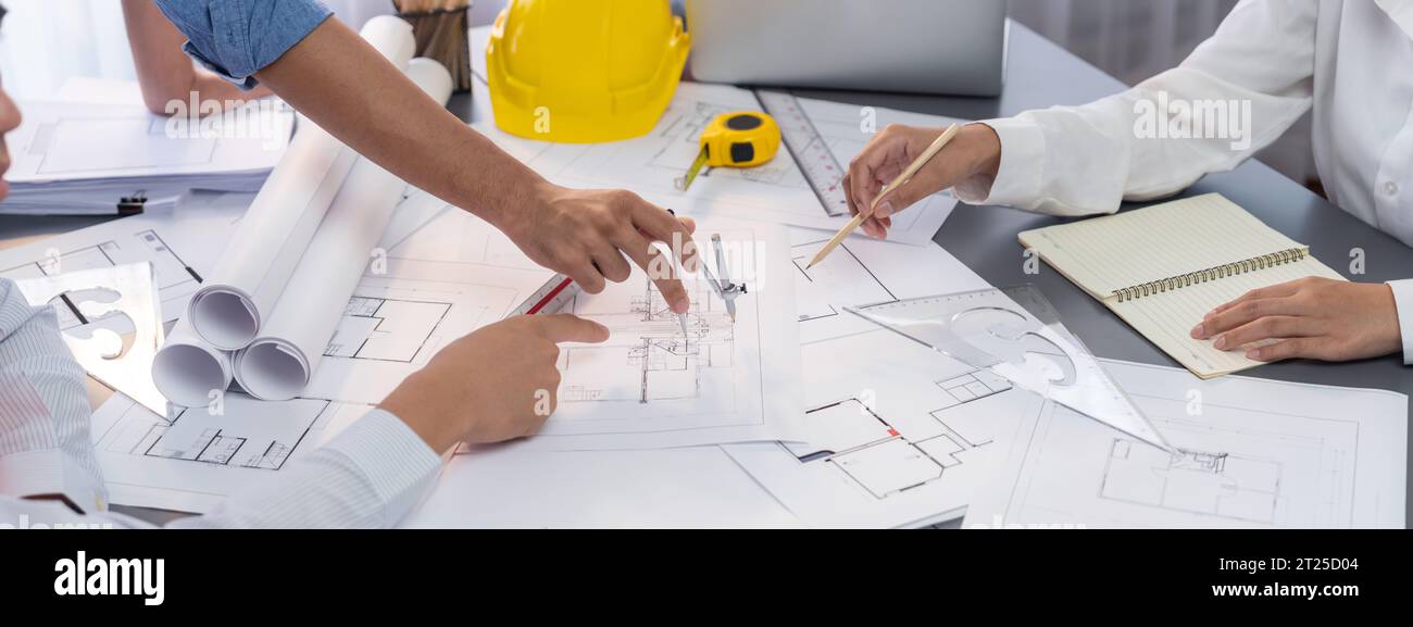 Architect or engineer working on building blueprint, contractor ...