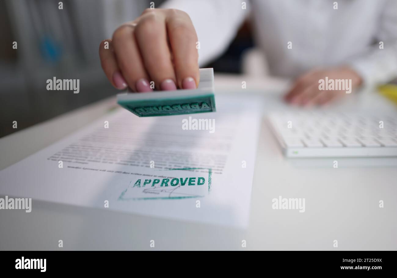 Green approved stamp on document, certificate contract, agreement ...