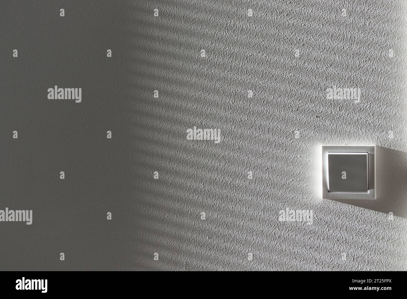 Light switcher on the white wall beneath rays of light banner Stock ...