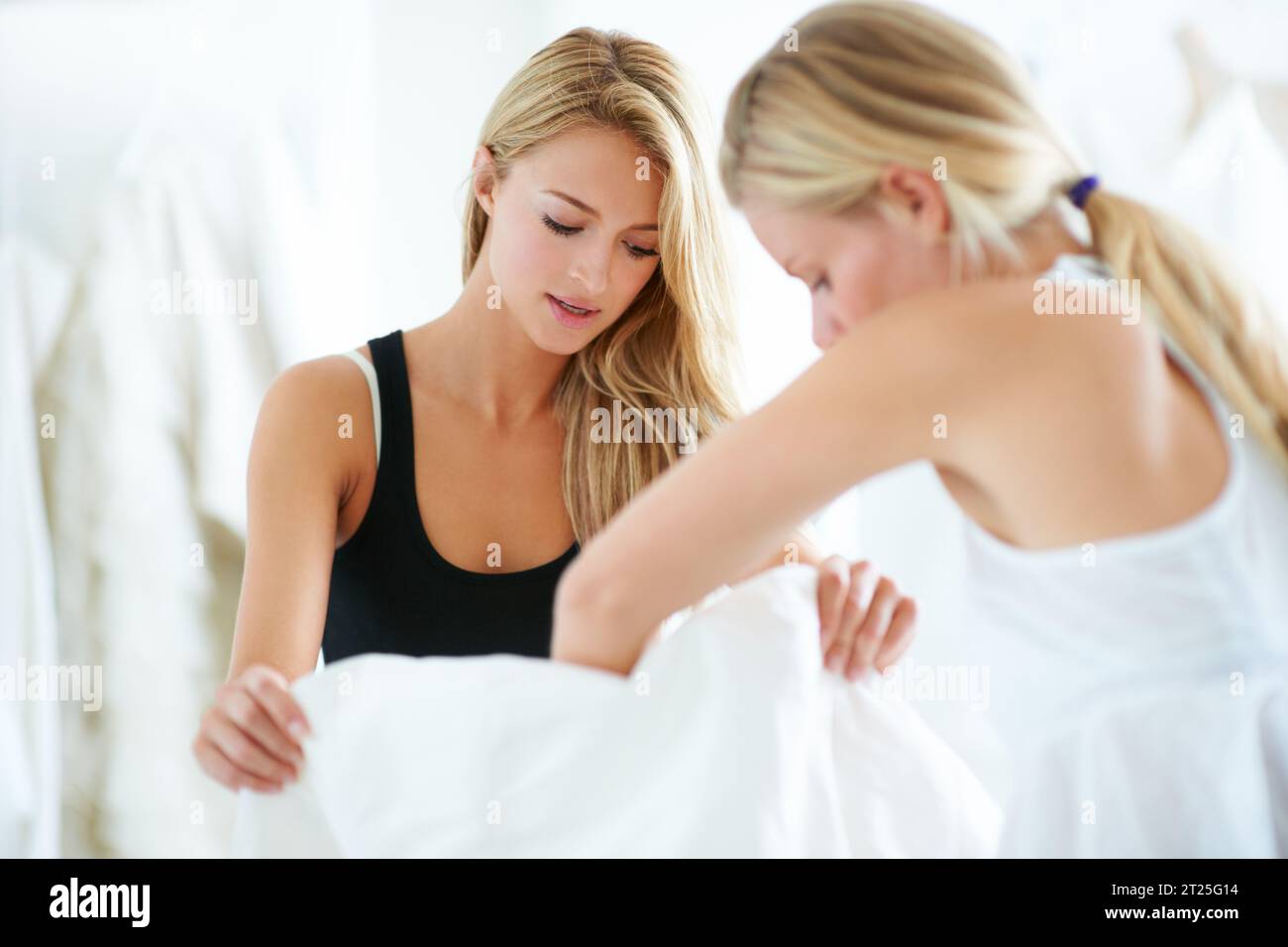 Boutique, wedding dress or woman helping a customer in store dressing ...