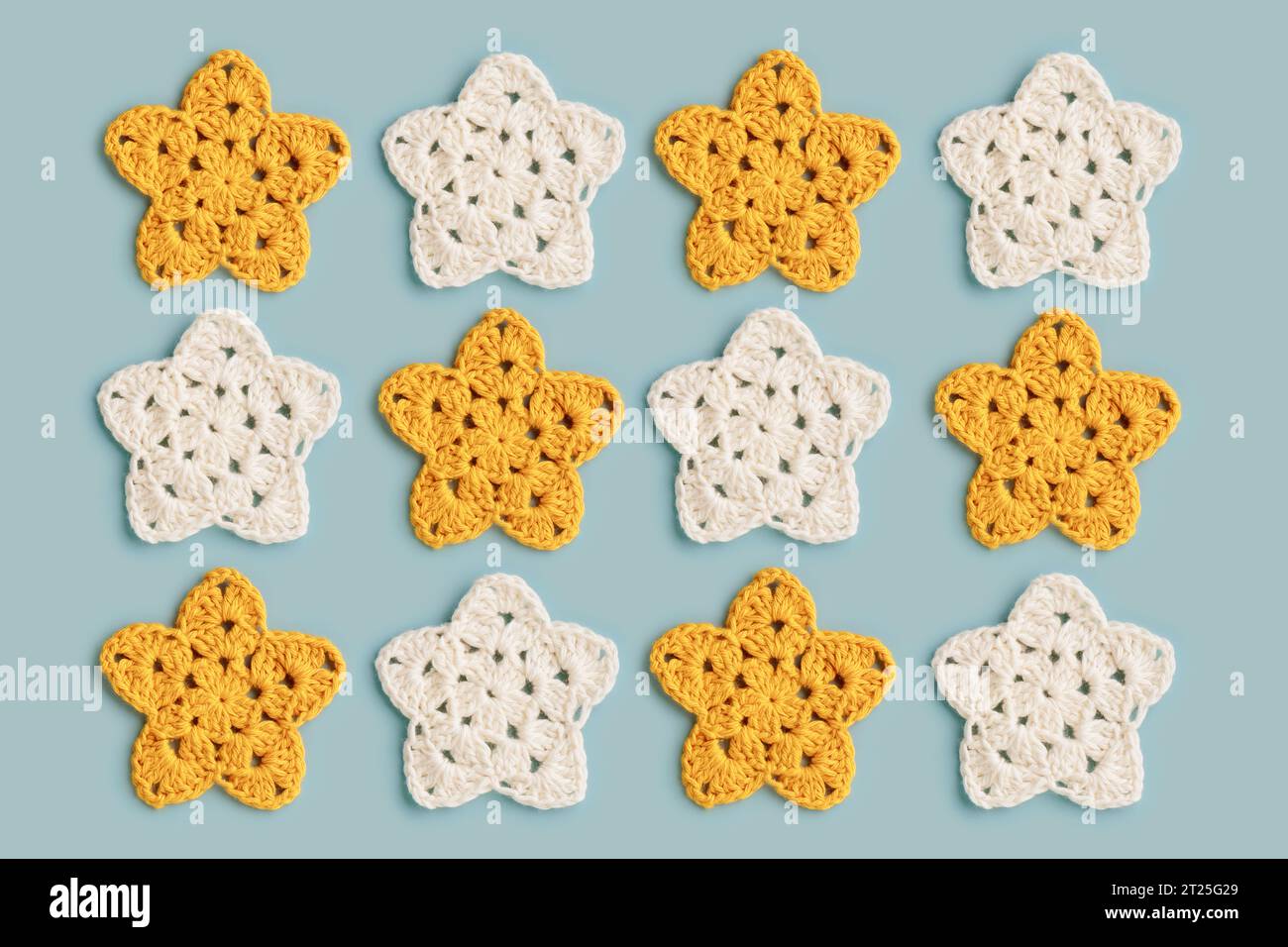 White and yellow crocheted stars pattern on a blue background Stock ...