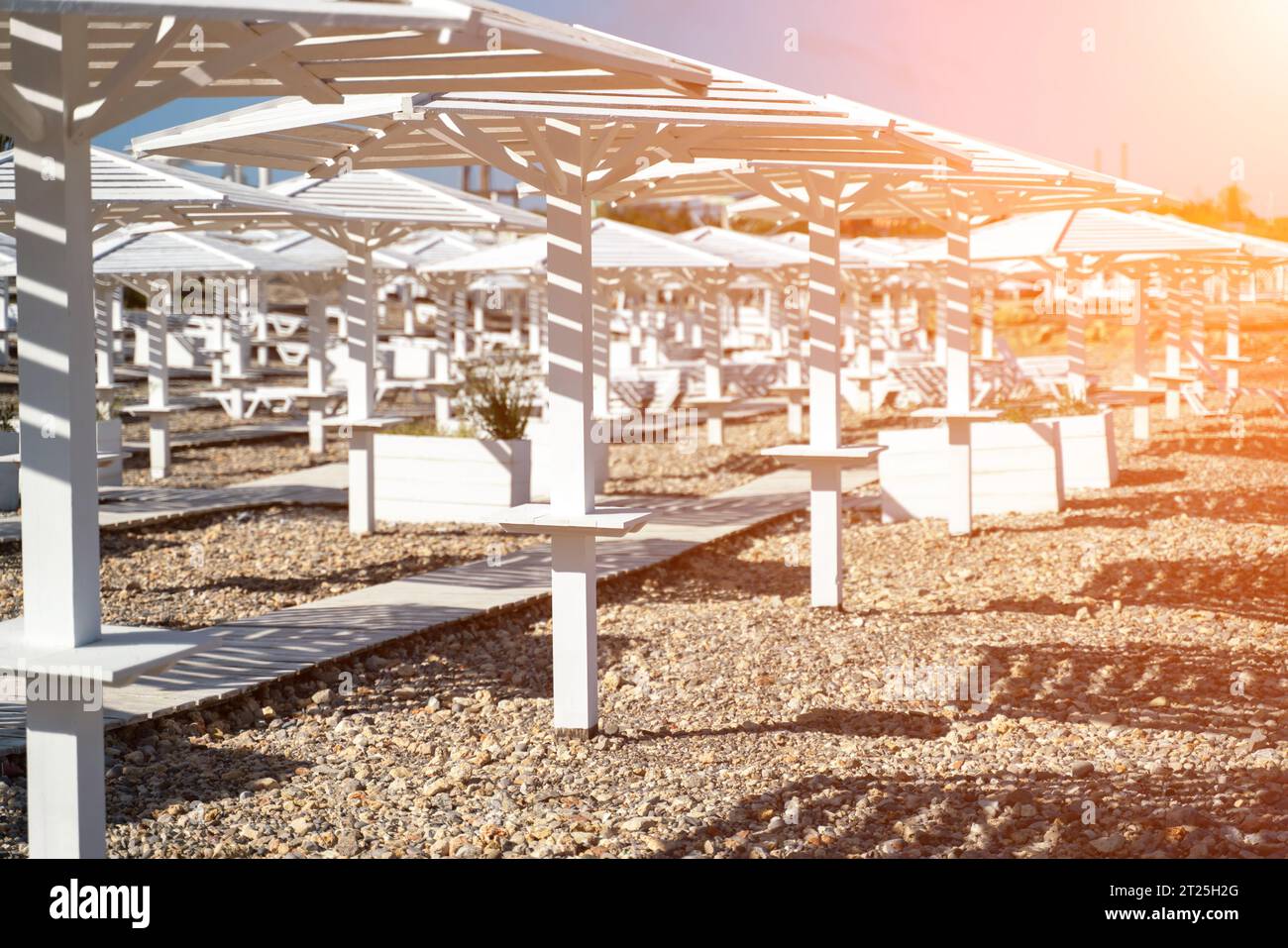 Rows of wooden umbrellas from the sun on the seashore in the morning ...