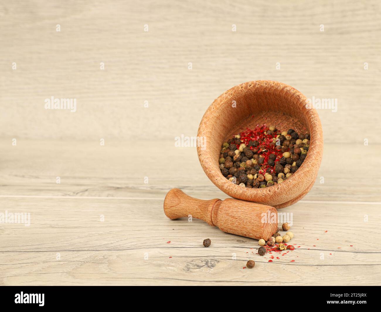 Mixed pepper in wooden mortar Stock Photo - Alamy