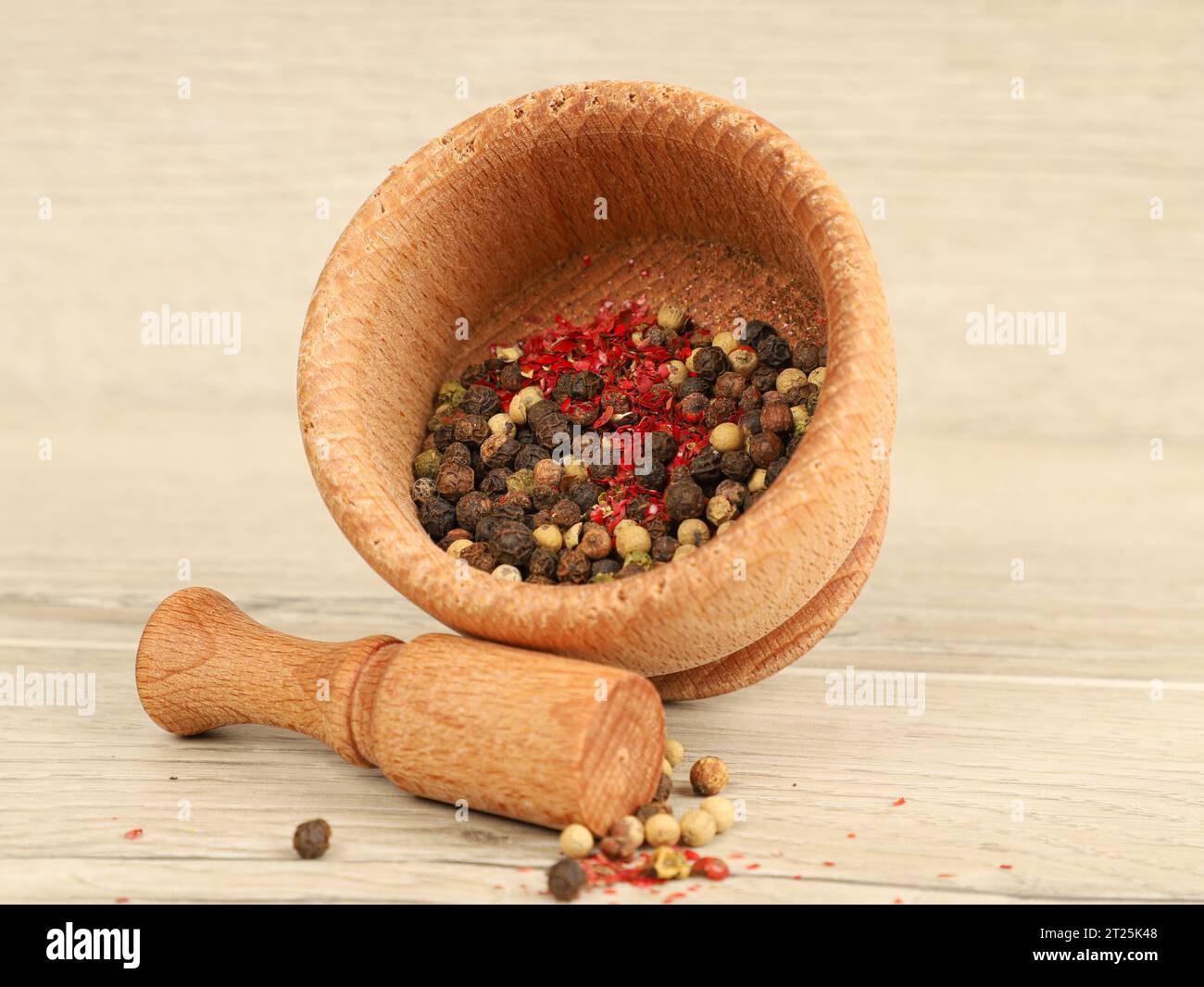 Mixed pepper in wooden mortar Stock Photo - Alamy