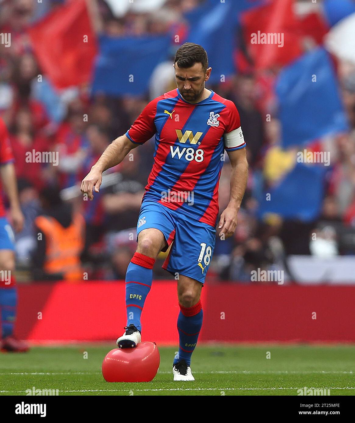 James McArthur of Crystal Palace pops a balloons on the Wembley Stadium ...