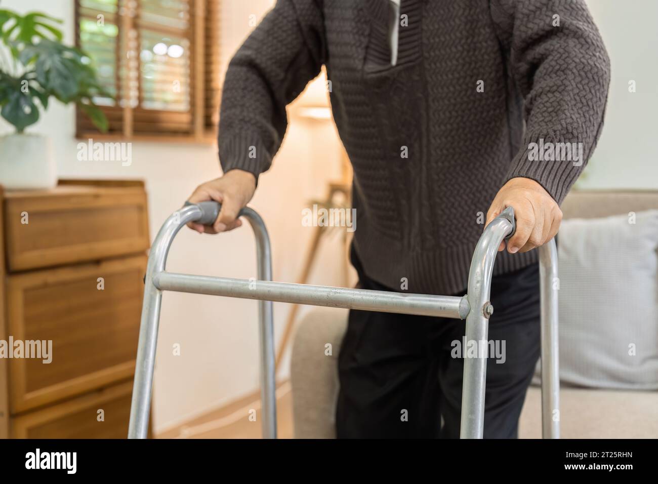 Retire senior using walker to help them walk at home. health care ...