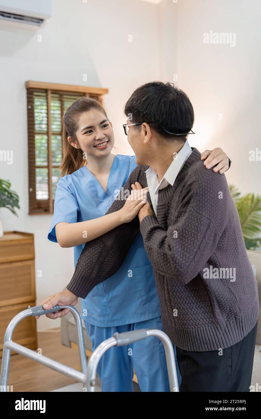 caregiver or nurse help support elderly are standing up without walker ...