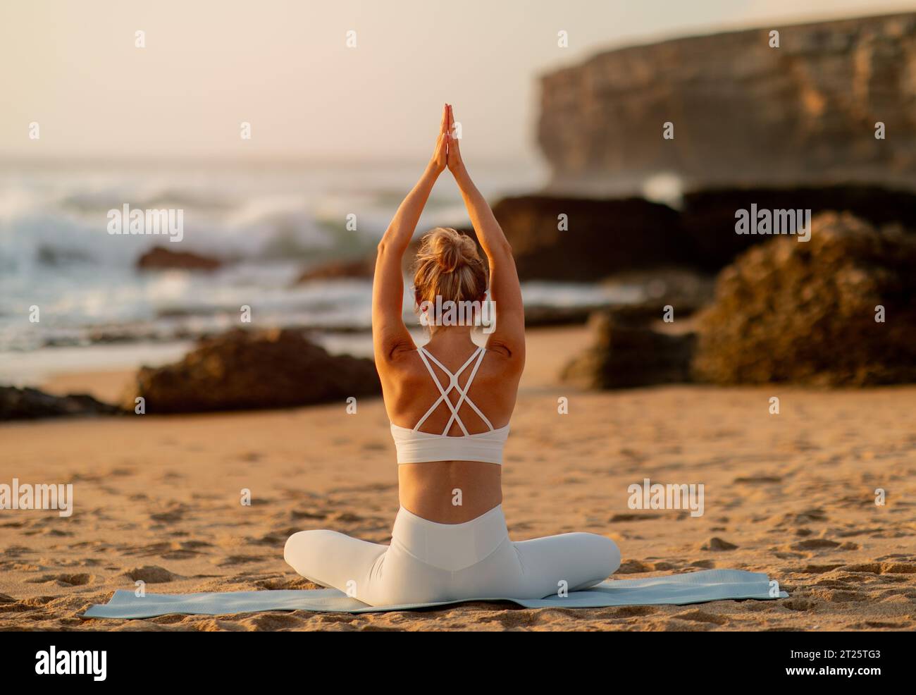 Back view woman meditating on the beach hi-res stock photography and ...