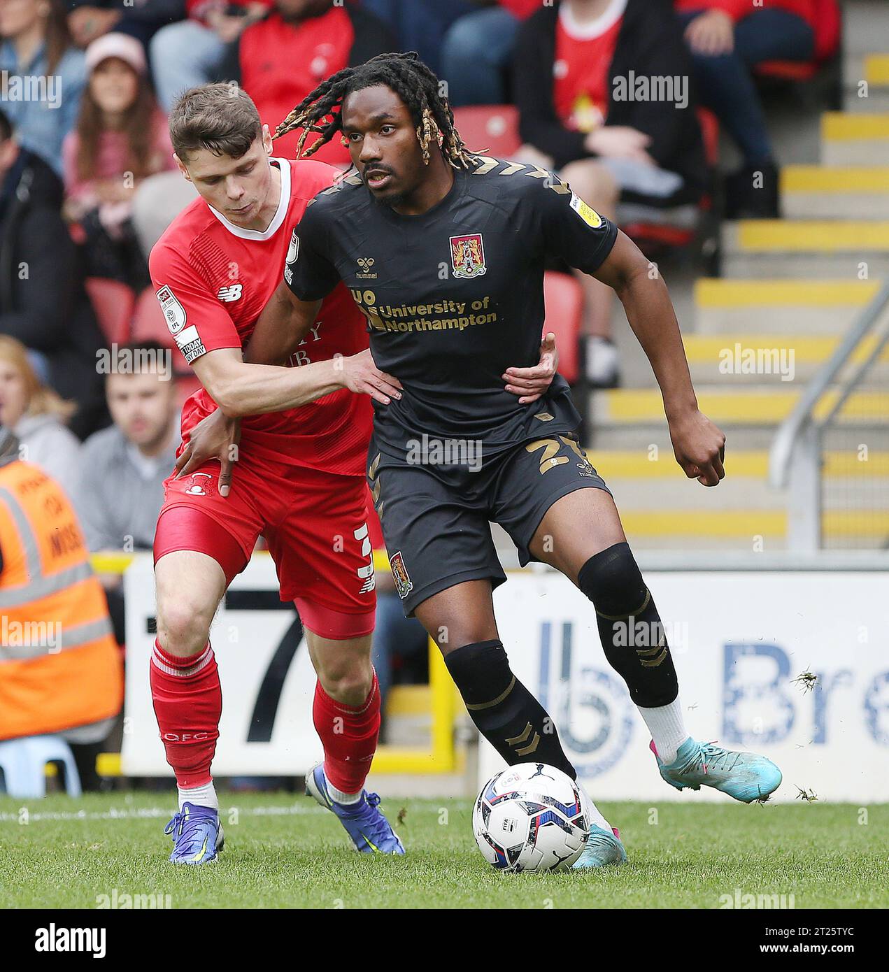 Josh Eppiah of Northampton Town battles for the ball with Connor Wood ...