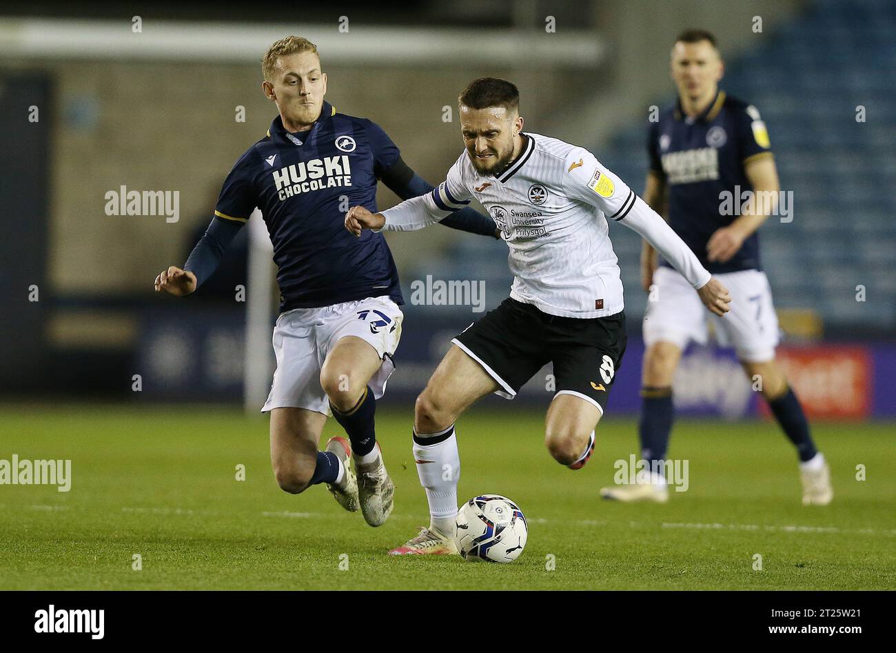 George Saville of Millwall battles for the ball with Matt Grimes of ...