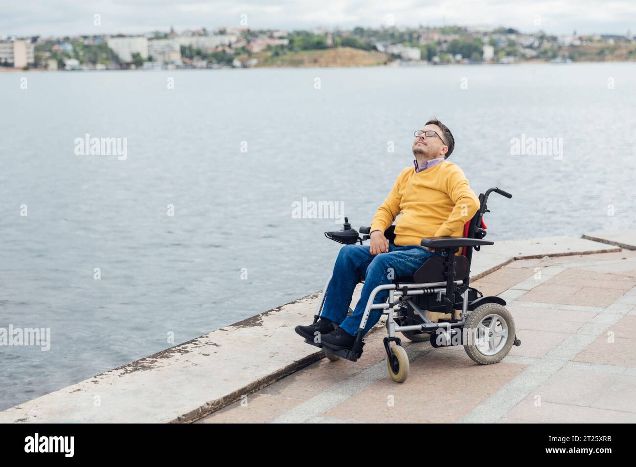 a special person with disabilities looks at the sea walk Stock Photo ...