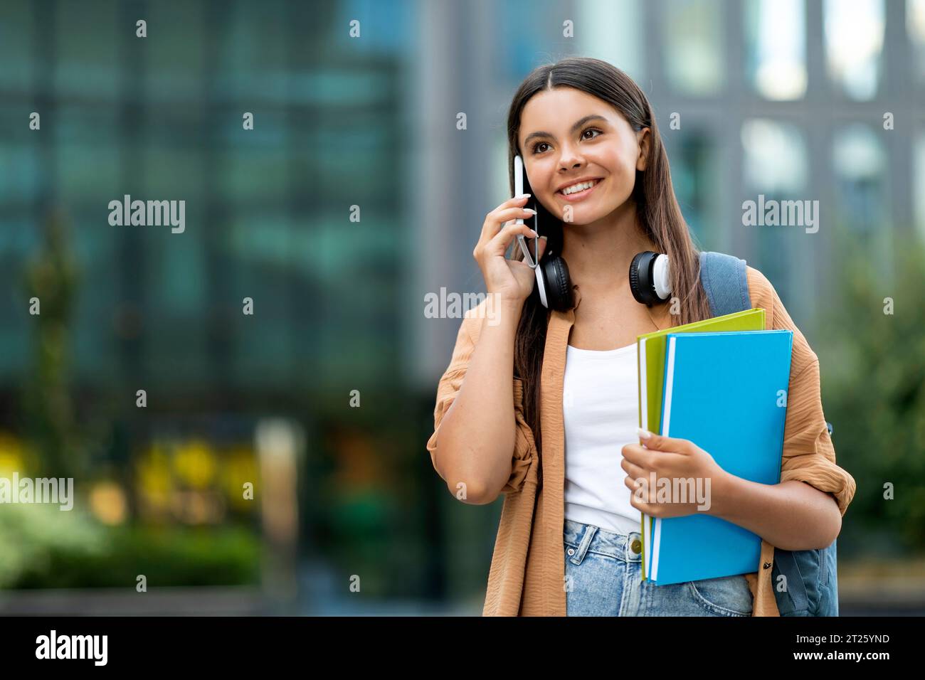 Happy pretty young woman student talking on phone outdoor Stock Photo ...