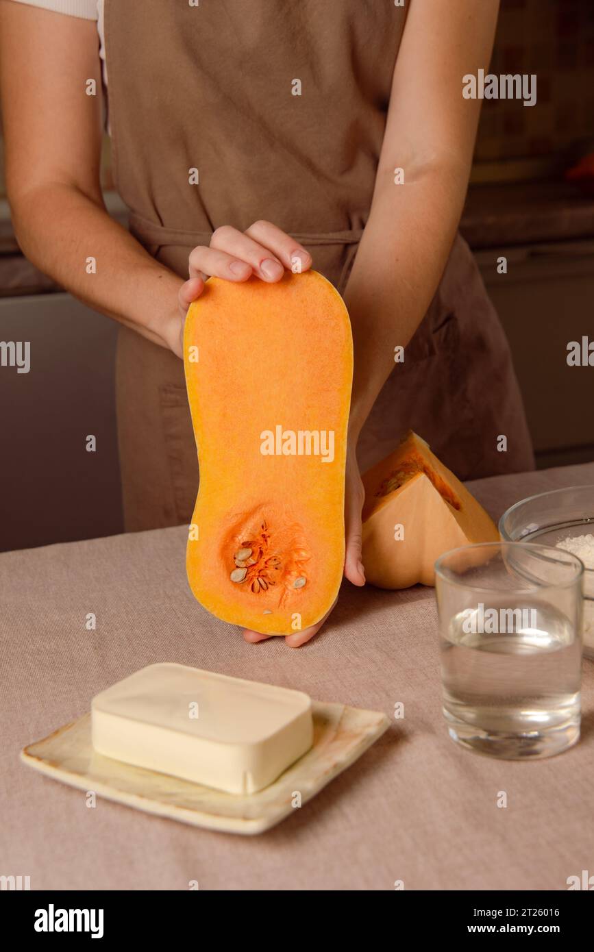 cooking easy and healthy pumpkin dish at home. pumpkin cut in half in ...