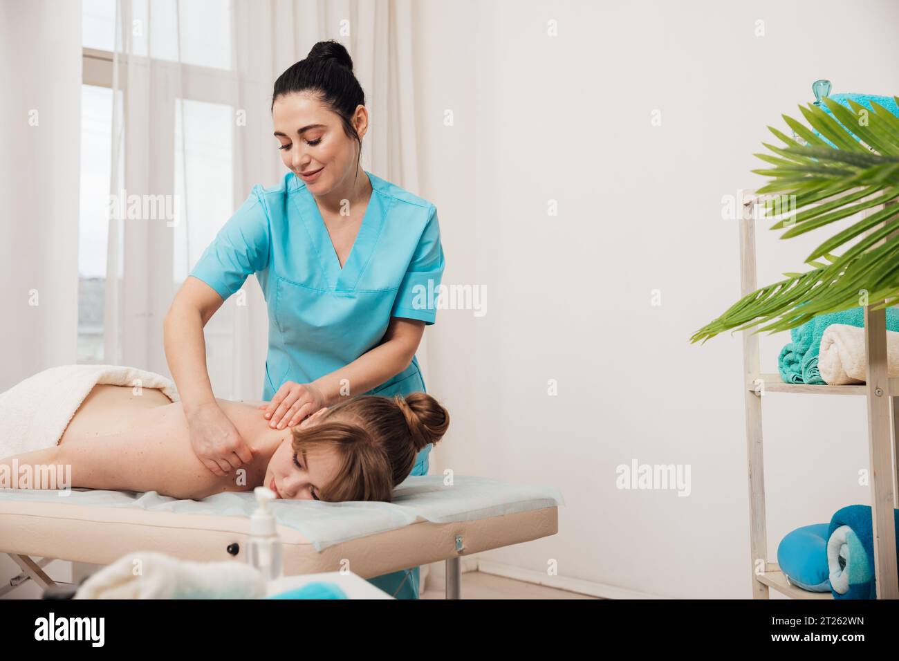 healthy back woman massages client in massage room spa training Stock Photo - Alamy